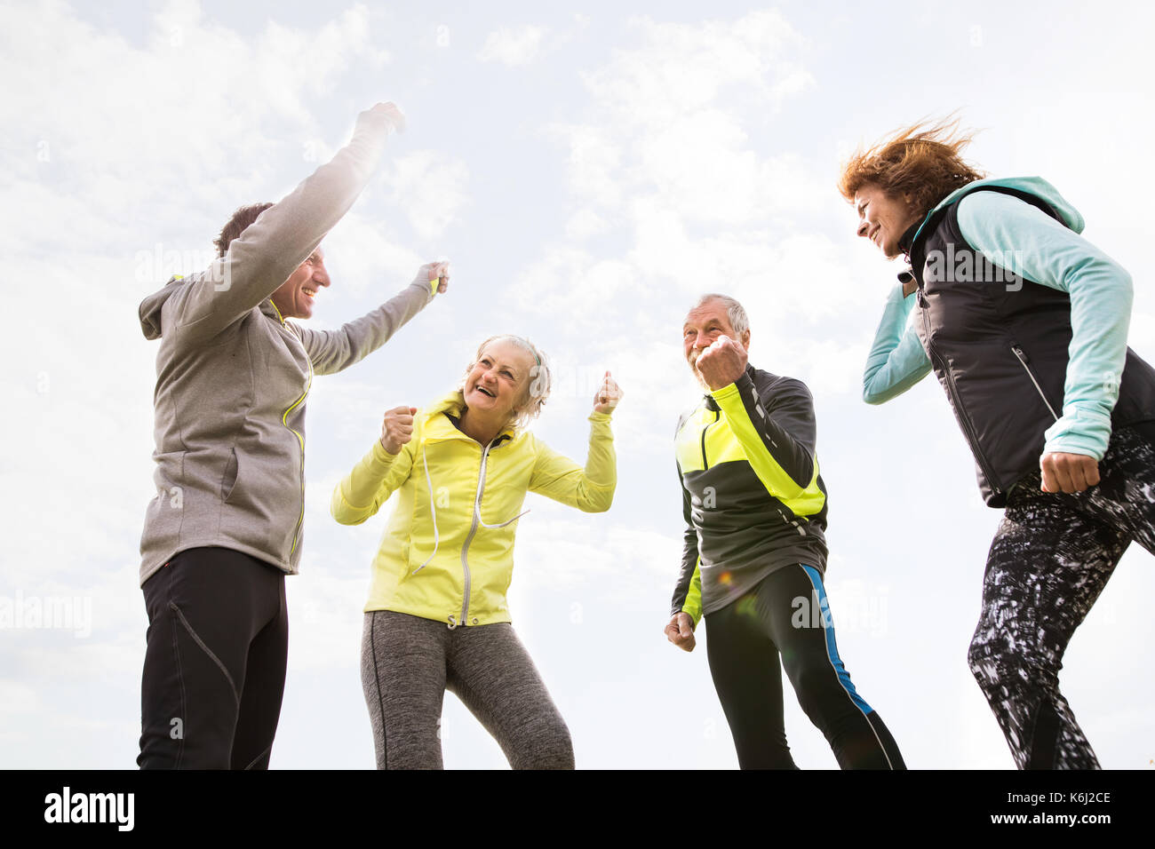 Senior runners outdoors, resting, hands in the air Stock Photo - Alamy