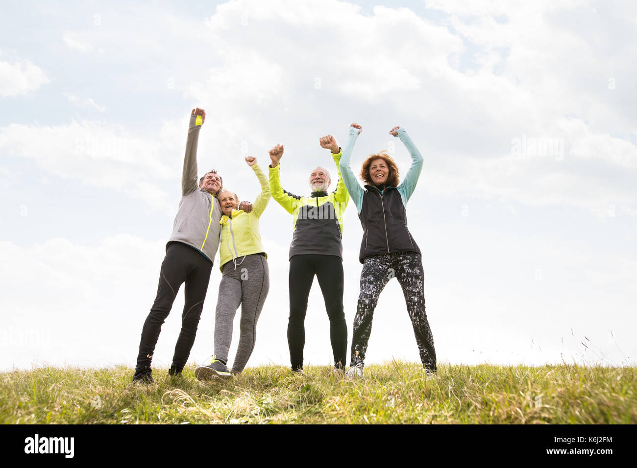 Senior runners outdoors, resting, hands in the air Stock Photo - Alamy