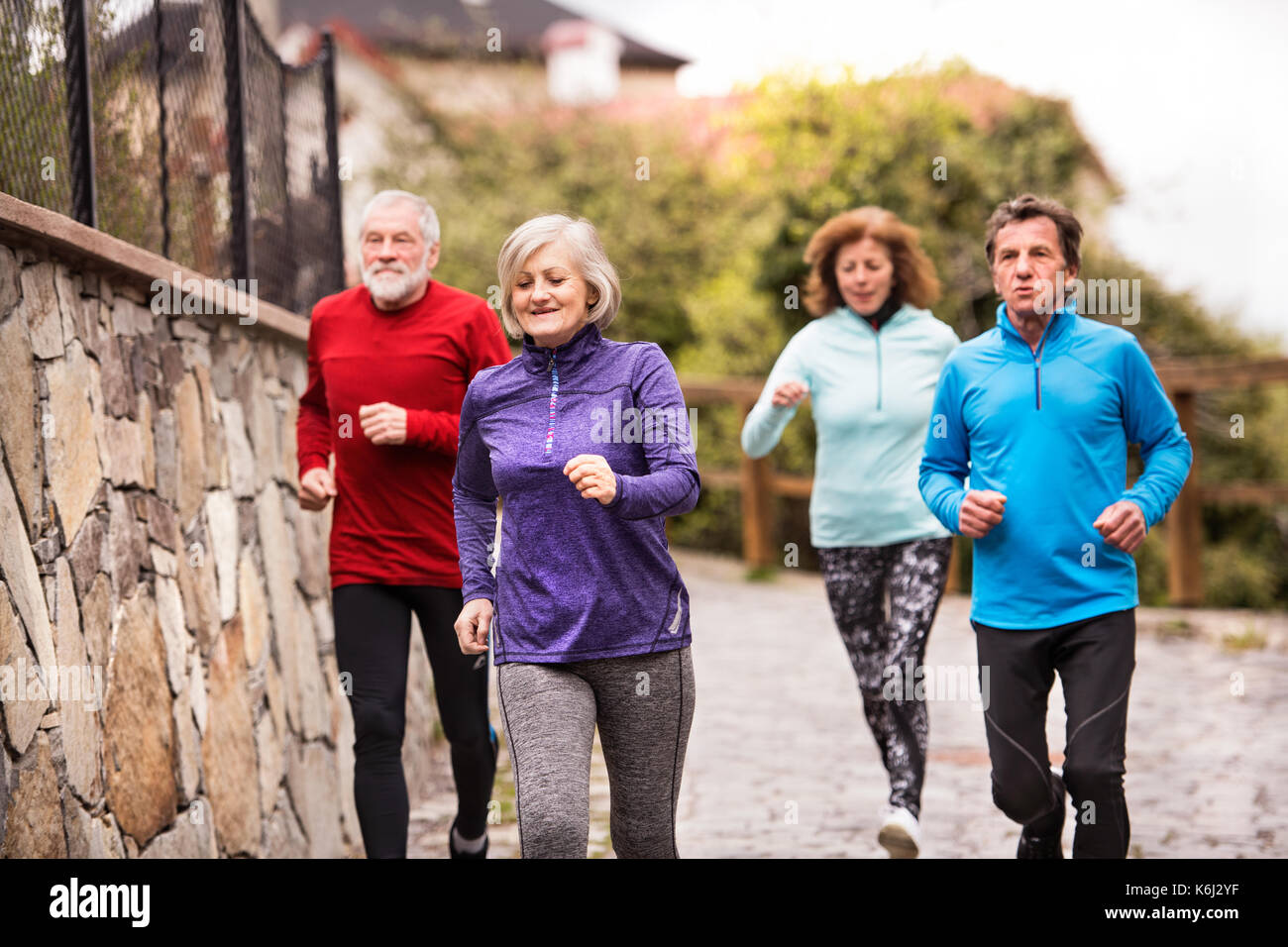 Group of seniors running outdoors in the old town Stock Photo - Alamy