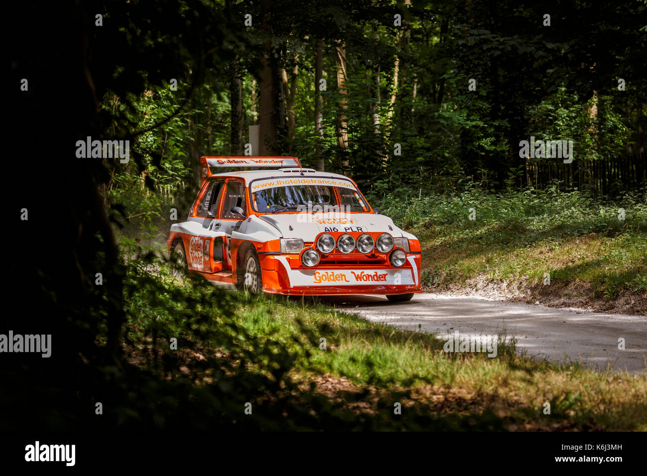 1986 MG Metro 6R4 Group B rally car on the forest stage with driver ...