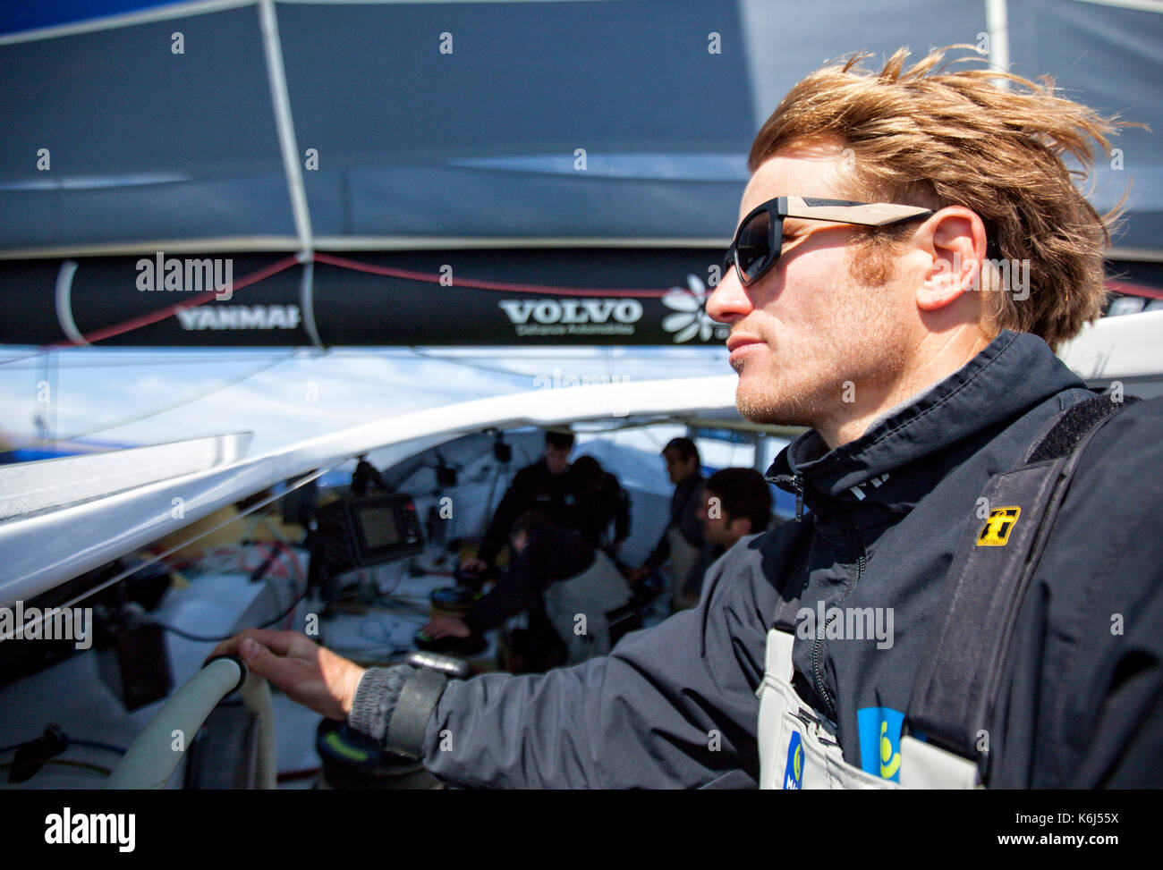 Sailor at helm steering trimaran, Atlantic Ocean, Brittany, France ...