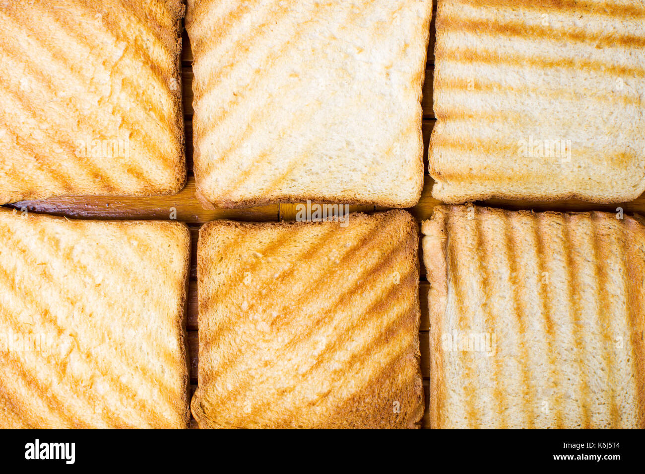 Toasted bread slices in golden color forming background Stock Photo - Alamy