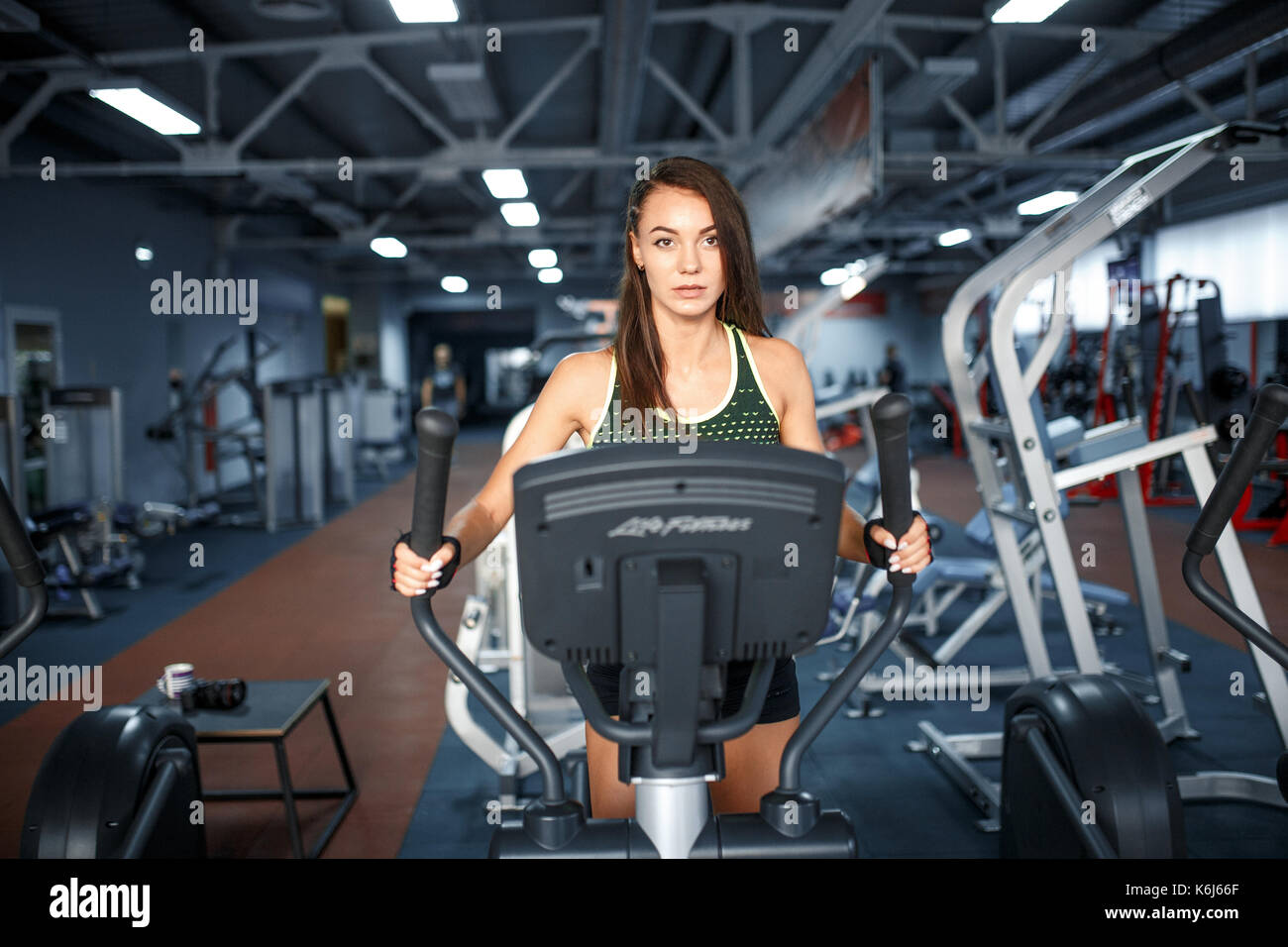 Young fitness woman doing cardio exercises at the gym running on a ...