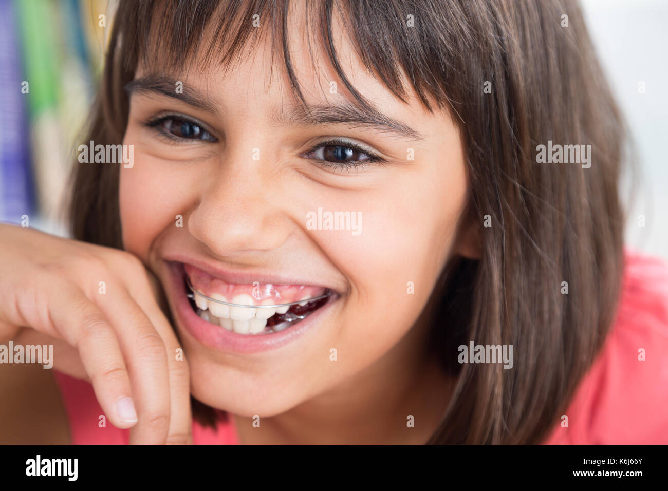 Portrait of a cute girl laughing wearing a removable orthodontic ...