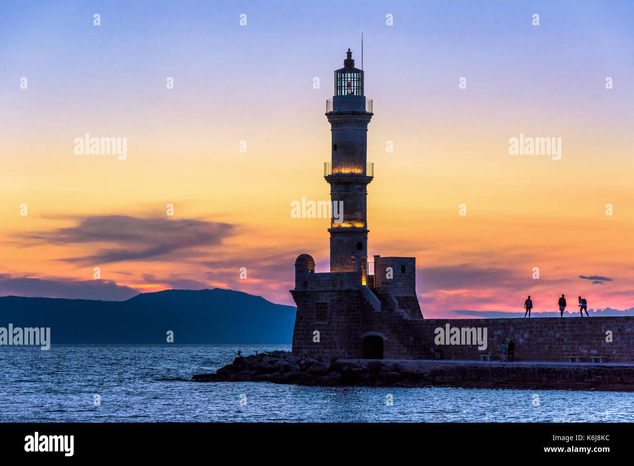 Lighthouse of the old Venetian port in Chania at sunrise Stock Photo ...