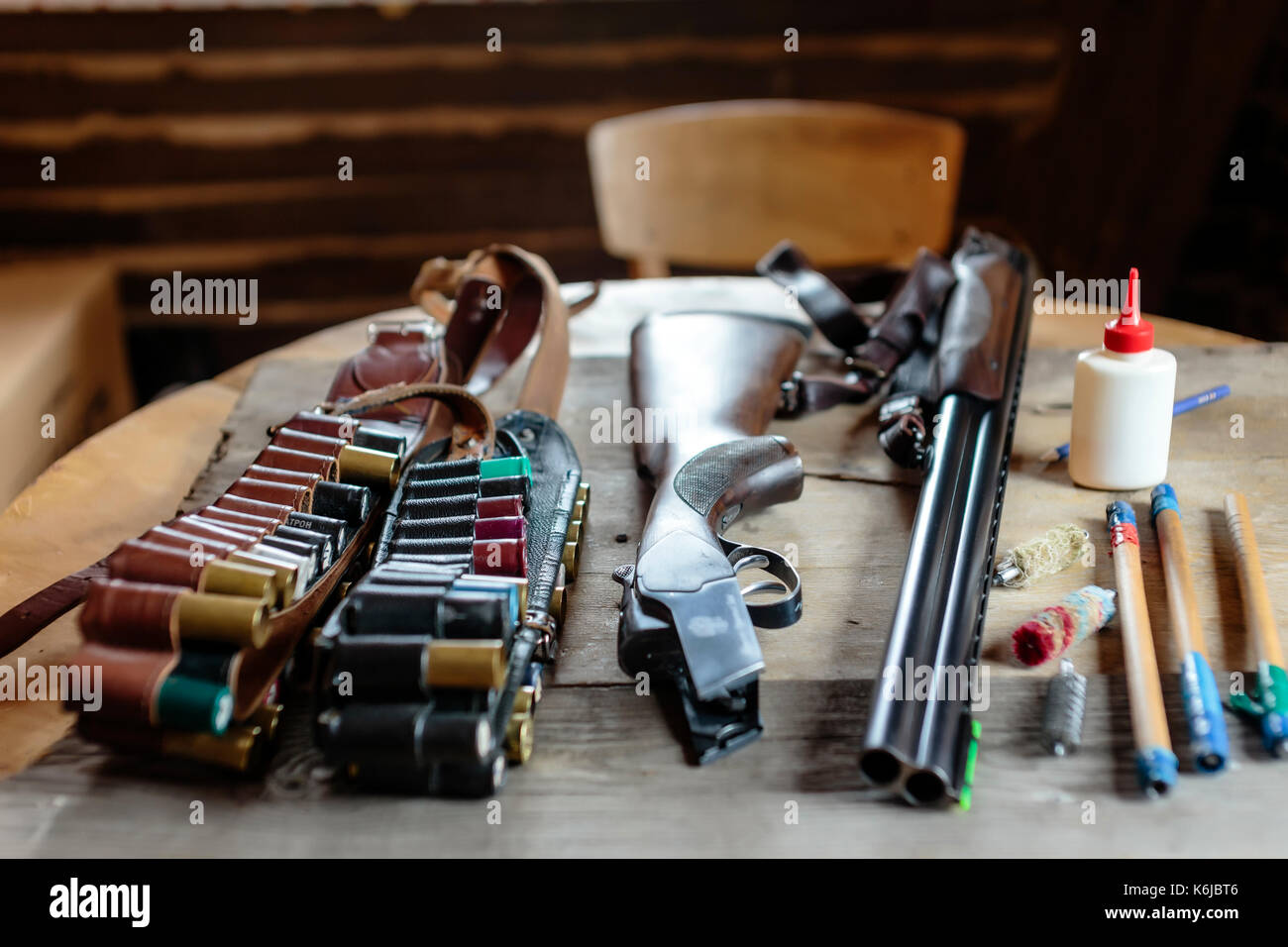 Close up of disassembled shotgun with ammunition and cleaning kit on ...
