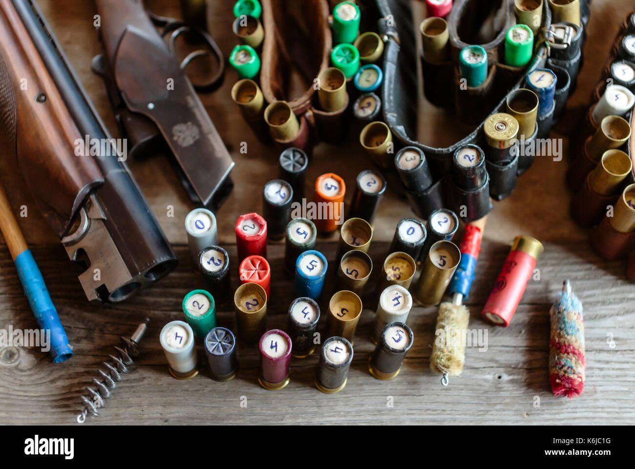 Close up of disassembled shotgun with ammunition and cleaning kit on ...