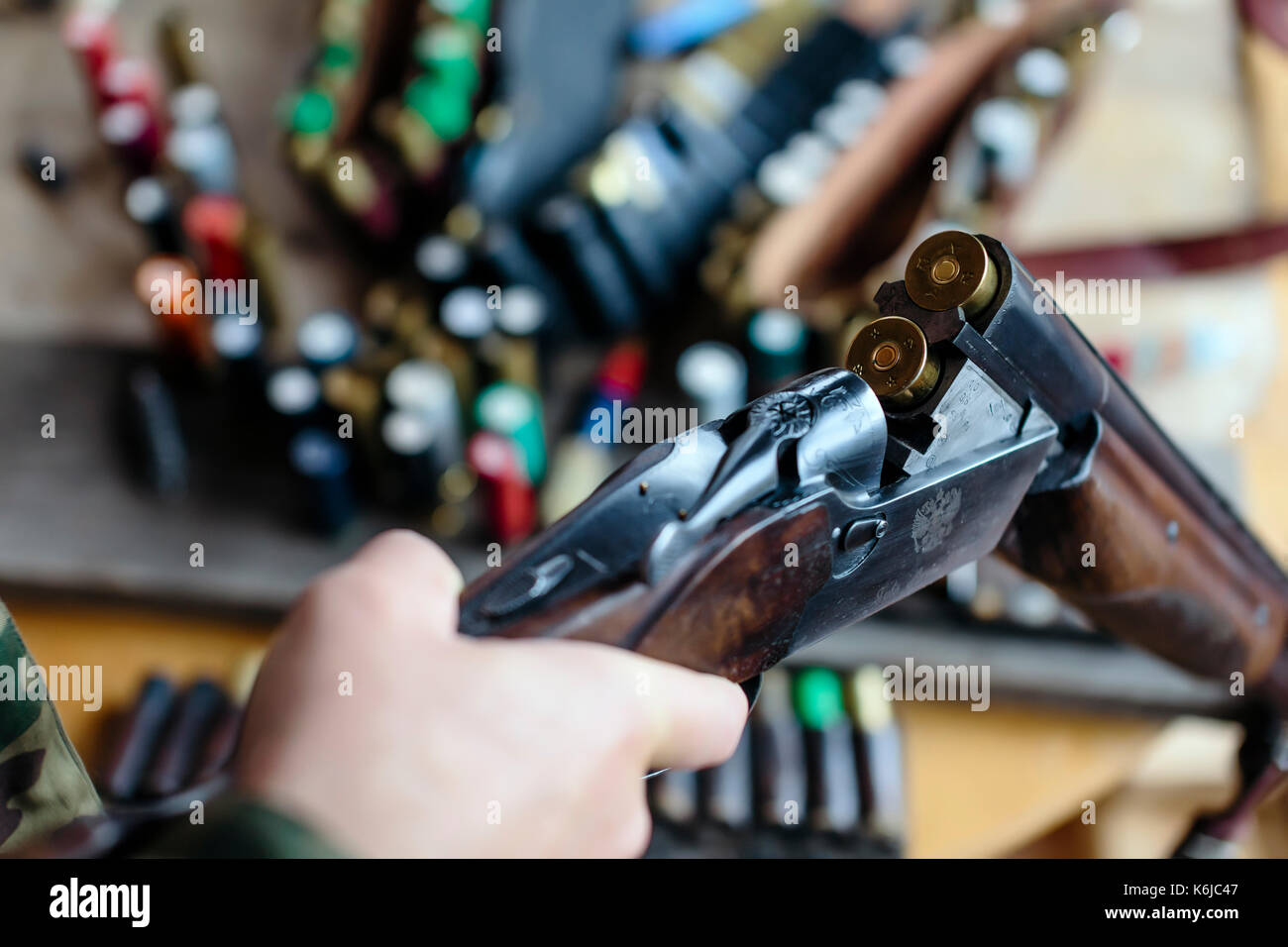 Close up of man hands loading shotgun with two shells, Tikhvin, Saint ...