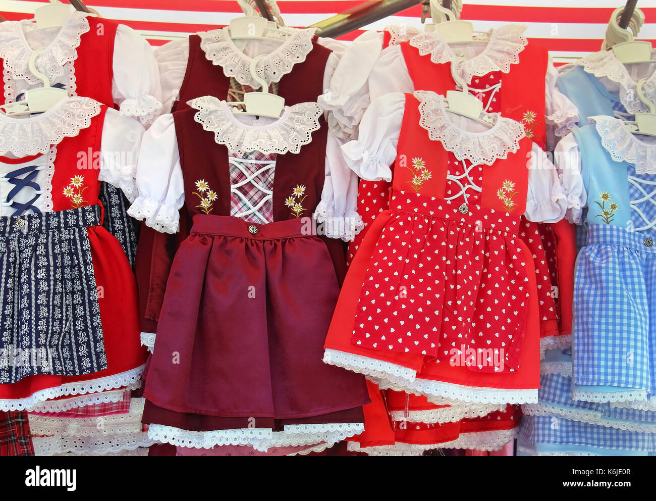 Colorful little girls dresses hanging on rack Stock Photo - Alamy