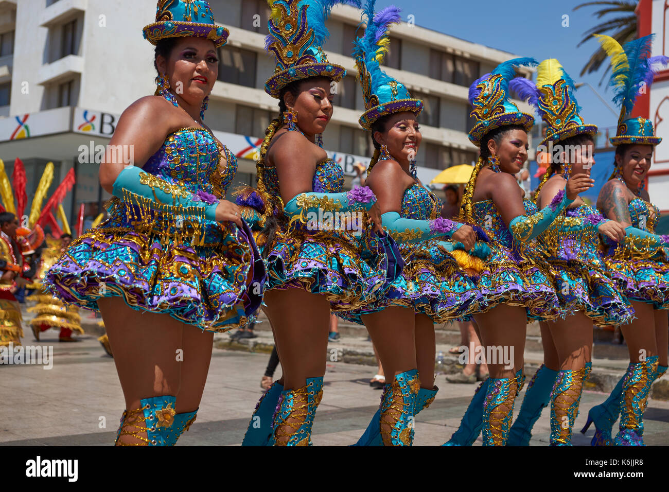 Female members of a Morenada dance group in ornate costumes performing ...