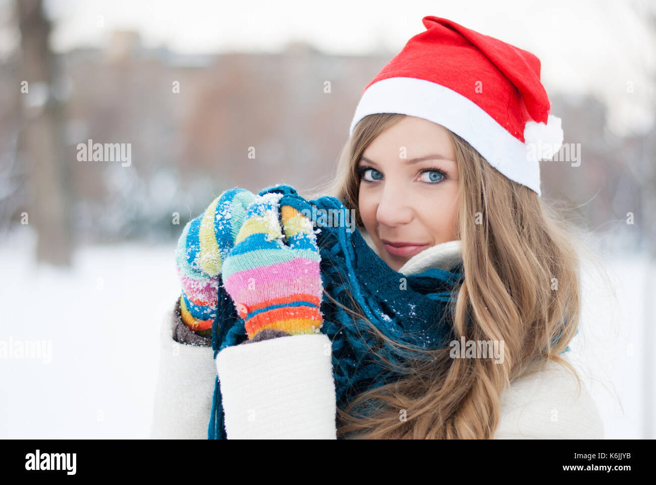 beautiful young girl posing in the snow with colorful gloves Stock ...