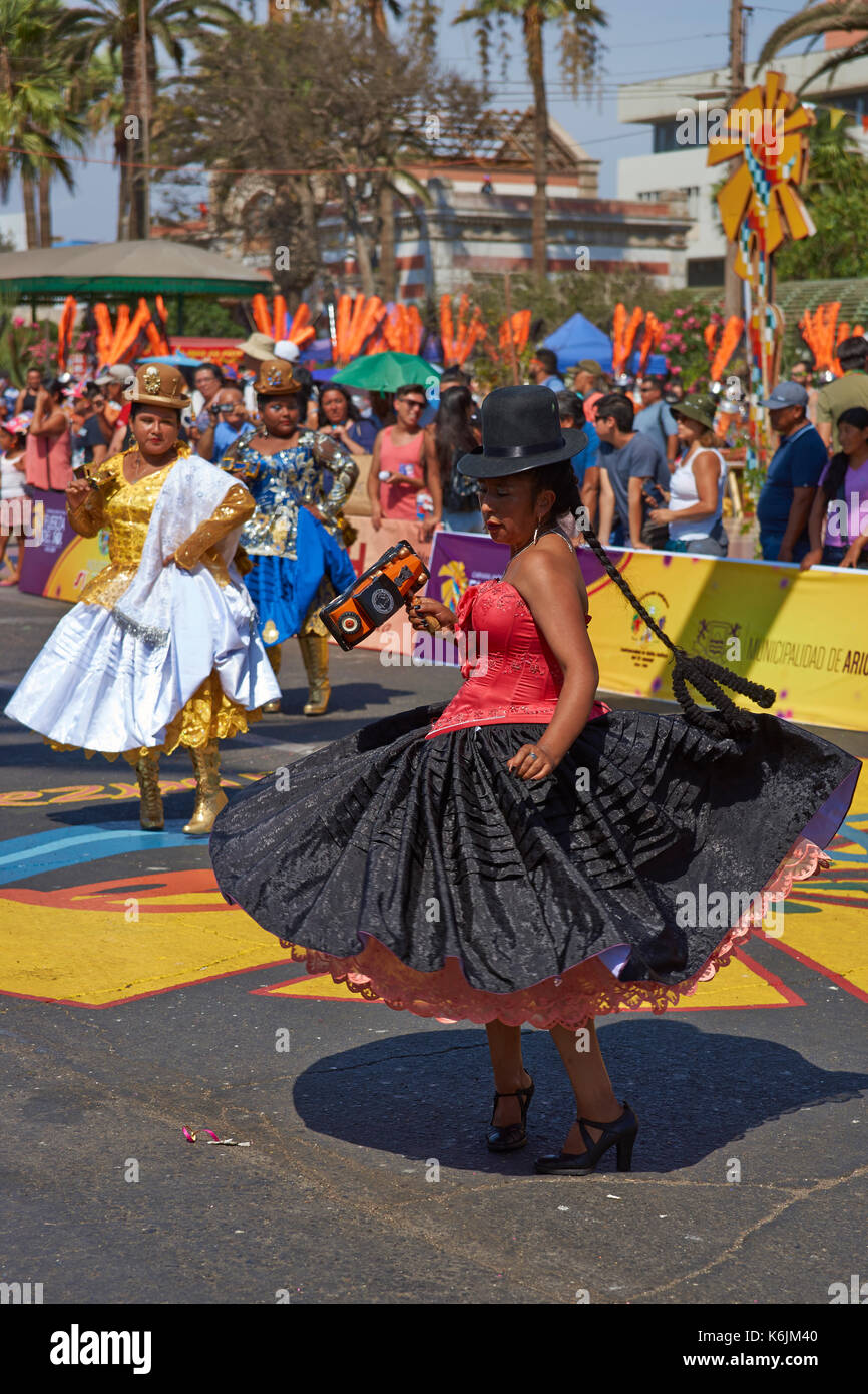 Female members of a Morenada dance group in ornate costumes performing ...