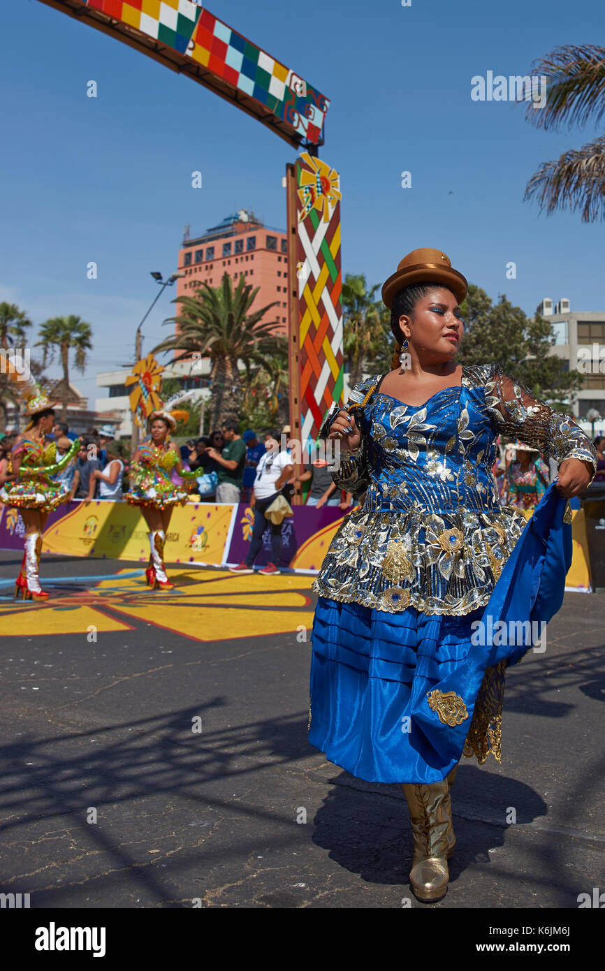 Female members of a Morenada dance group in ornate costumes performing ...