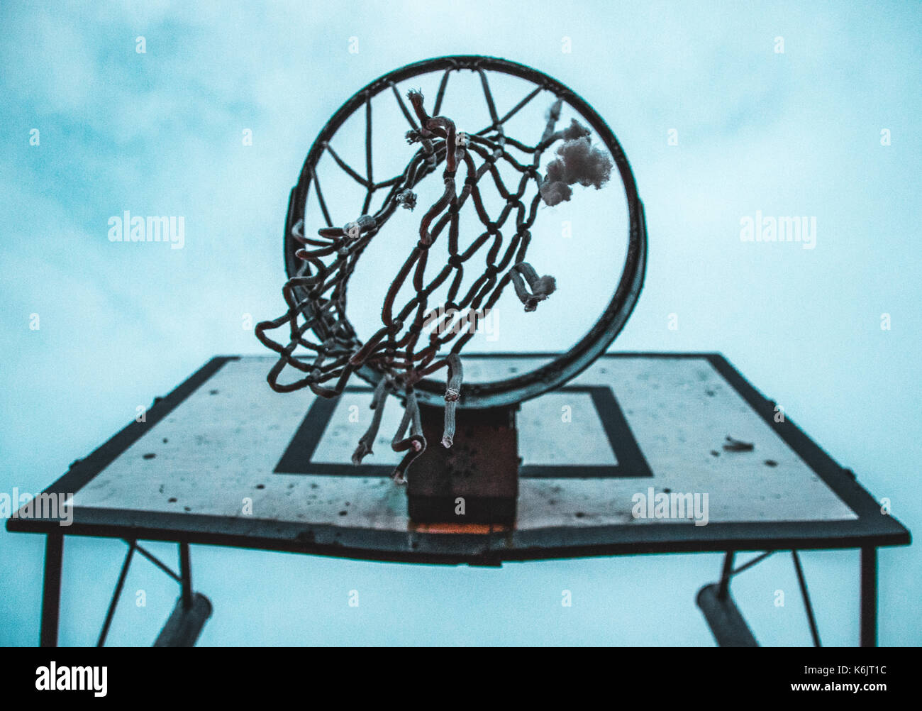 Underside shot of Urban Basketball hoop with worn out ripped net Stock ...