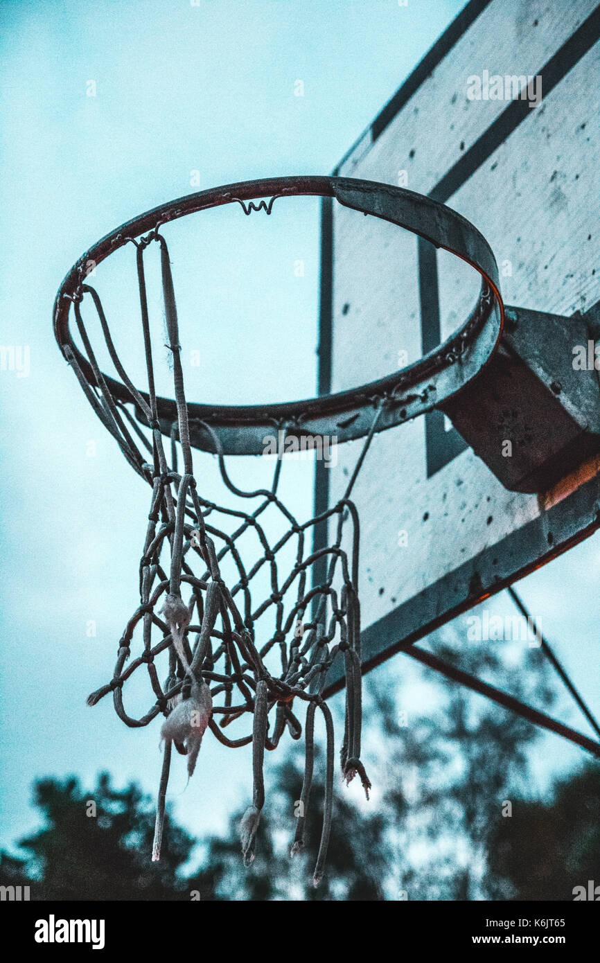Urban Basketball hoop with worn out ripped net Stock Photo - Alamy