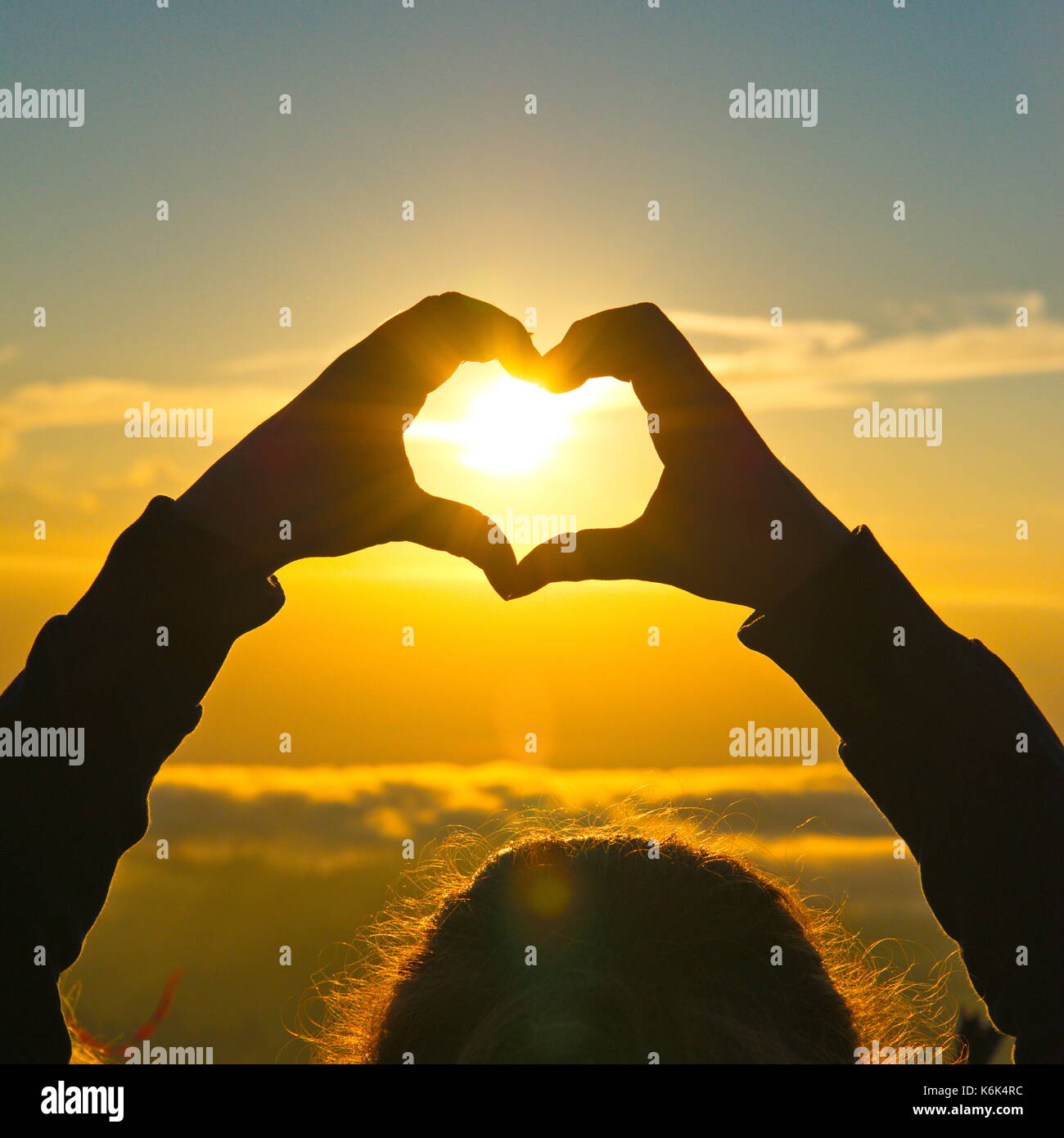 Girl forming a heart with her hand Stock Photo - Alamy