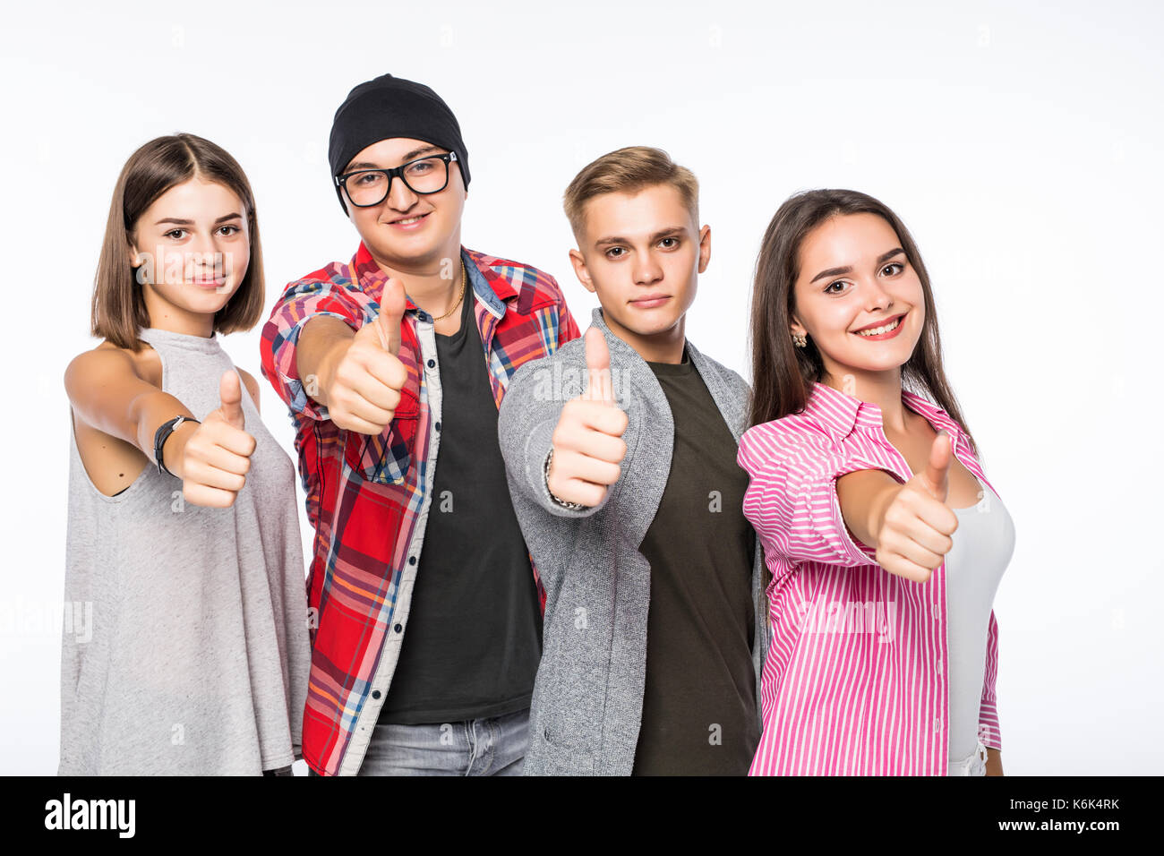 Happy group of young friends giving thumbs up on white background Stock ...