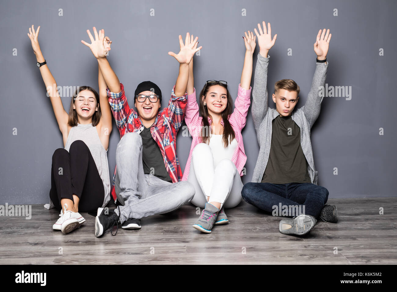 happy group of friends smiling and holding Stock Photo - Alamy