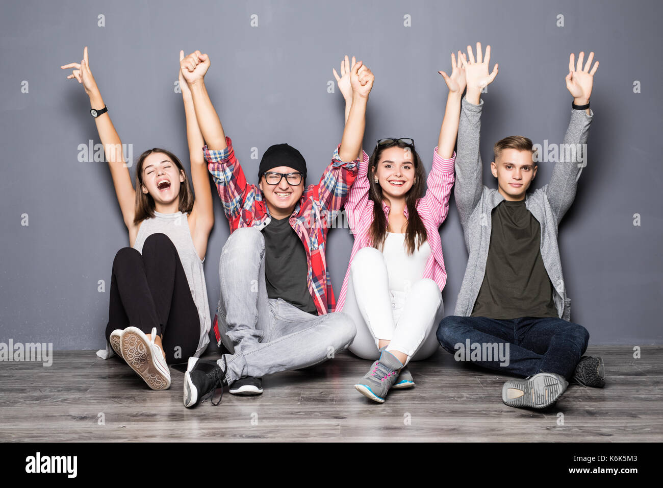 happy group of friends smiling and holding Stock Photo - Alamy