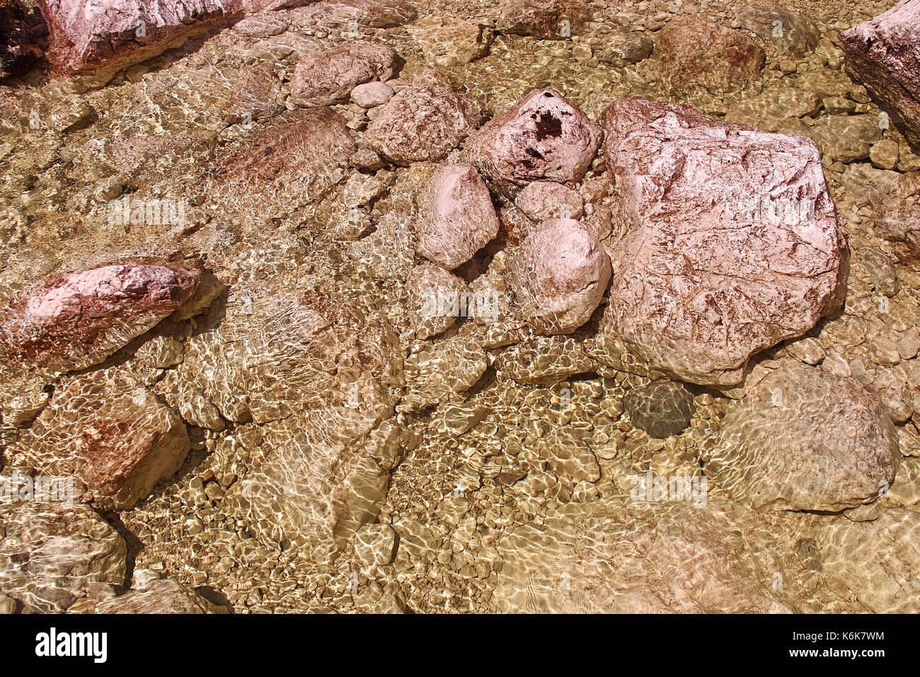 Pink rocks in a clear water of a mountain stream Stock Photo - Alamy