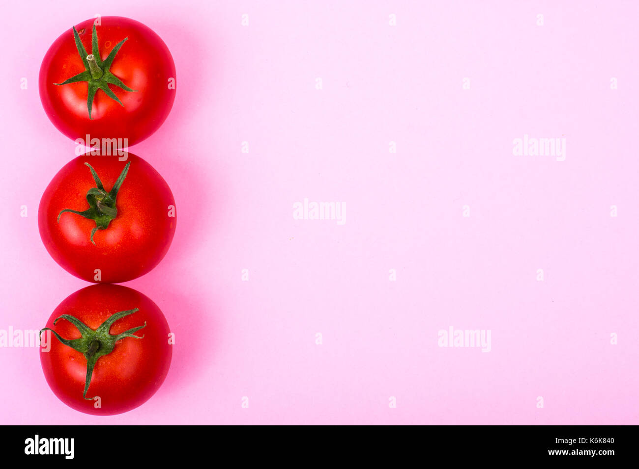 Pastel bright background with red tomatoes. Studio Photo Stock Photo ...