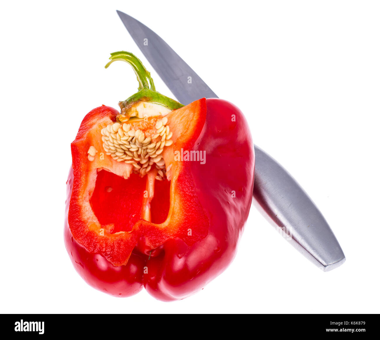 Cut red sweet pepper with seeds on white background. Studio Photo Stock ...