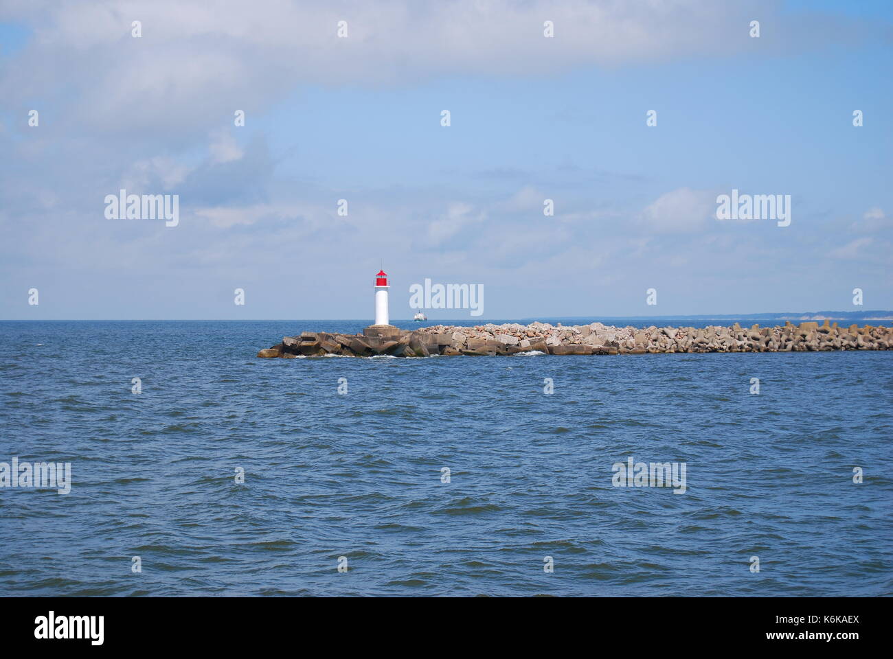Lighthouse in a jetty pier Stock Photo - Alamy