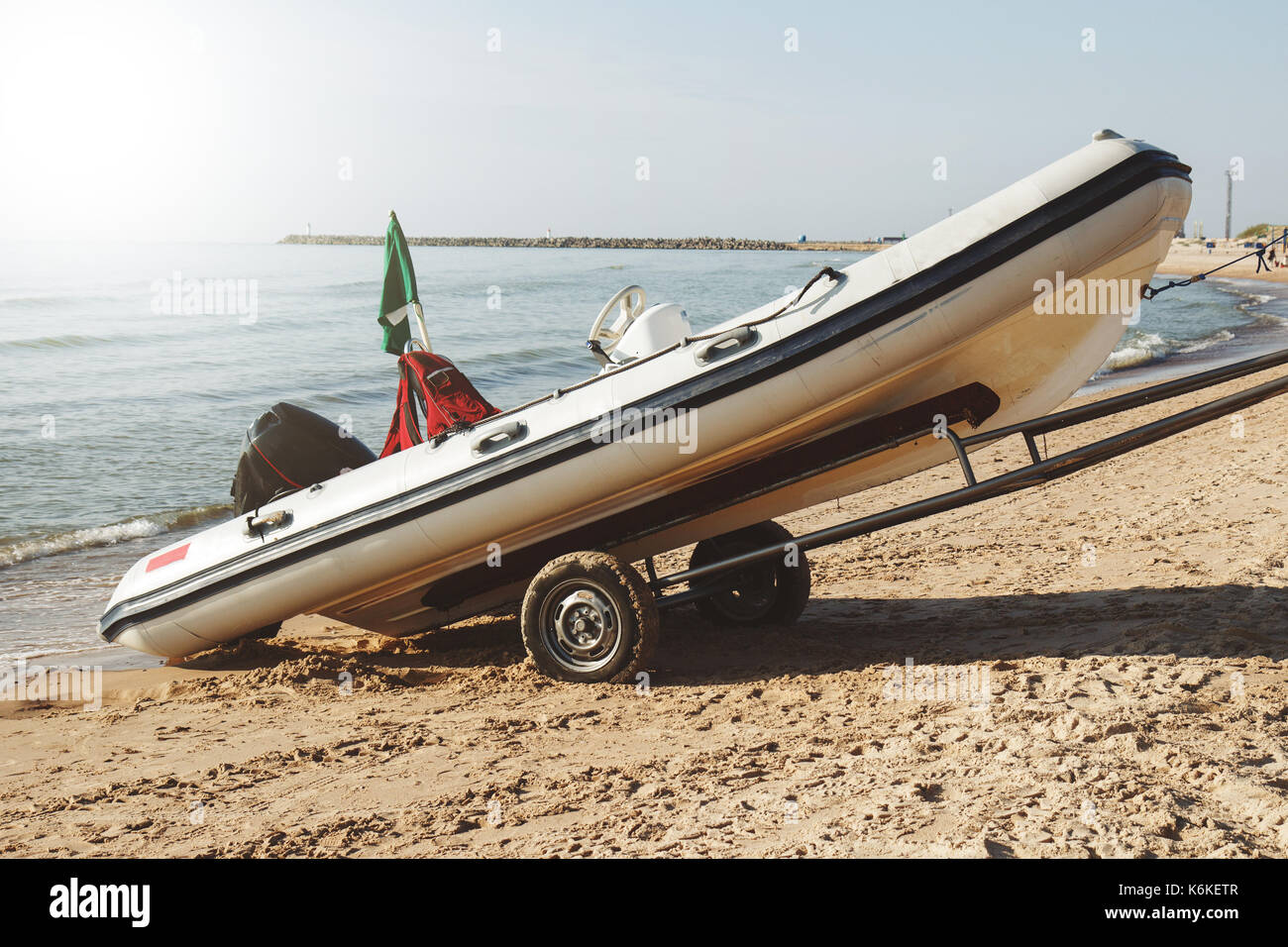 beach lifeguard boat on the sandy beach in evening sun Stock Photo - Alamy