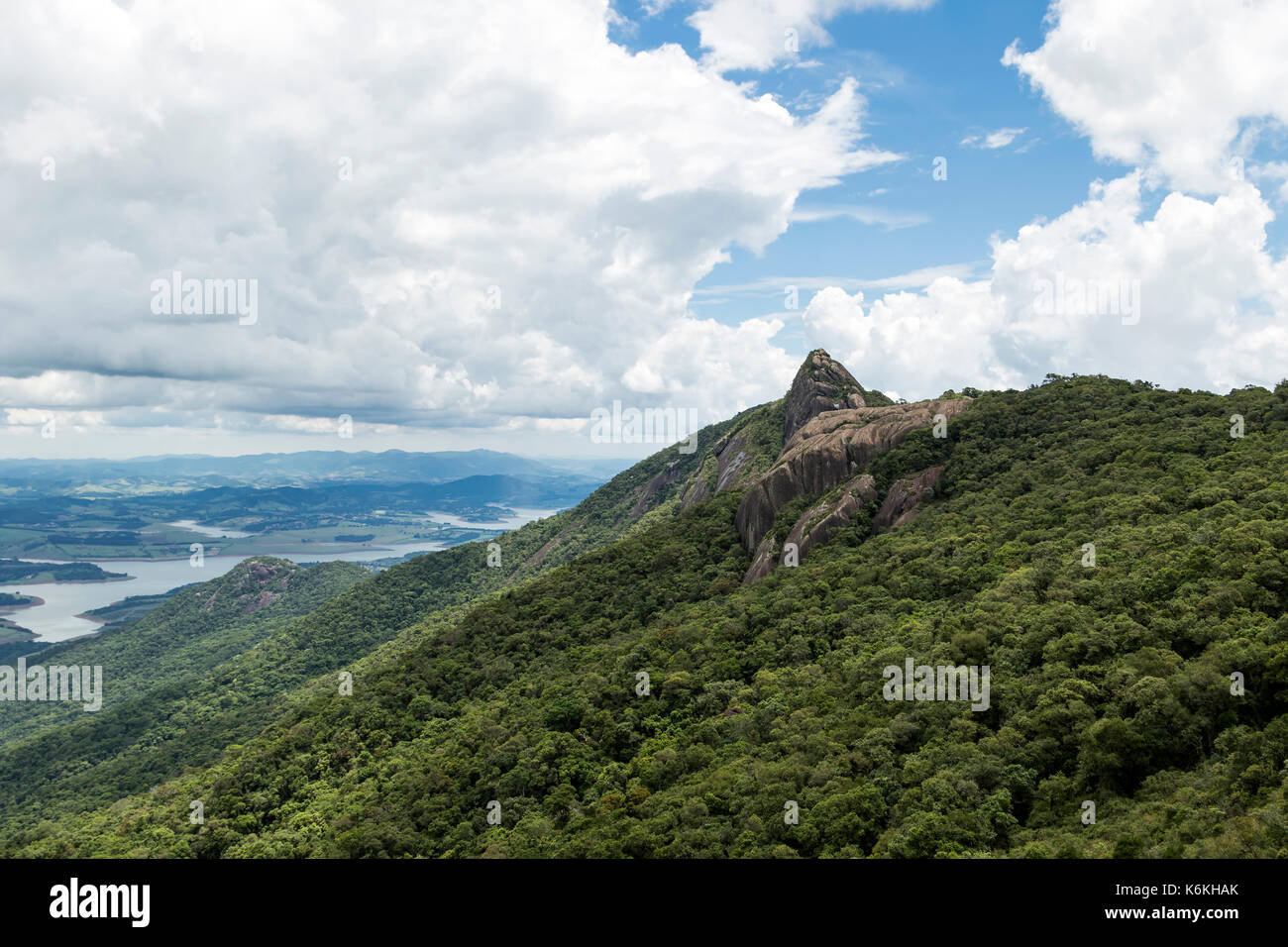 horizontal wide angle view of a mountain rock face with some trees ...