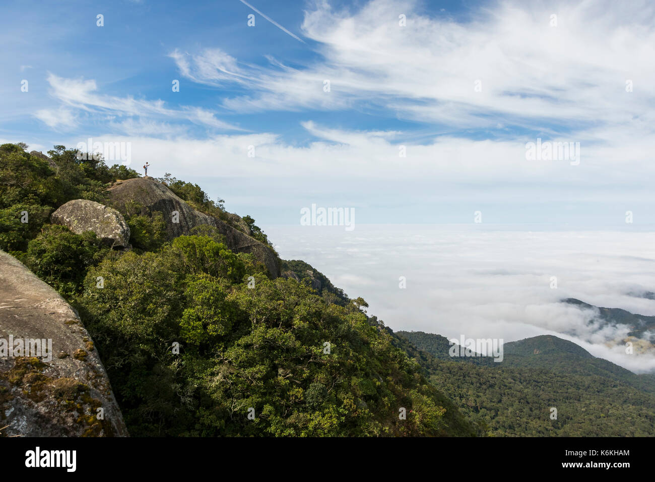 lone hiker at the mountain summit above the clouds Stock Photo - Alamy