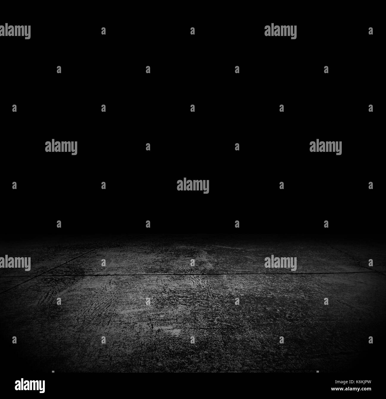 An empty grunge cement floor in the dark for horror or scary background ...