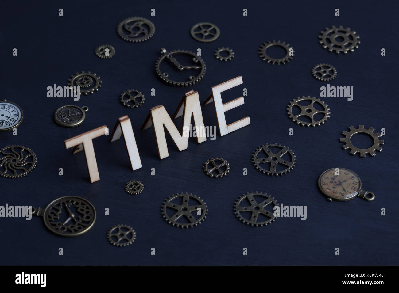 The word Time on dark background with cog wheels and vintage clocks ...