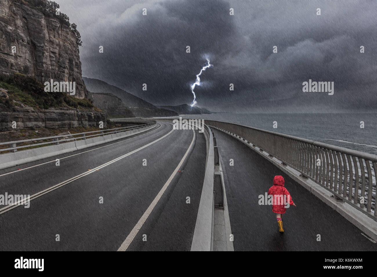 Child running on a huge bridge during thunderstorm. Concept of ...