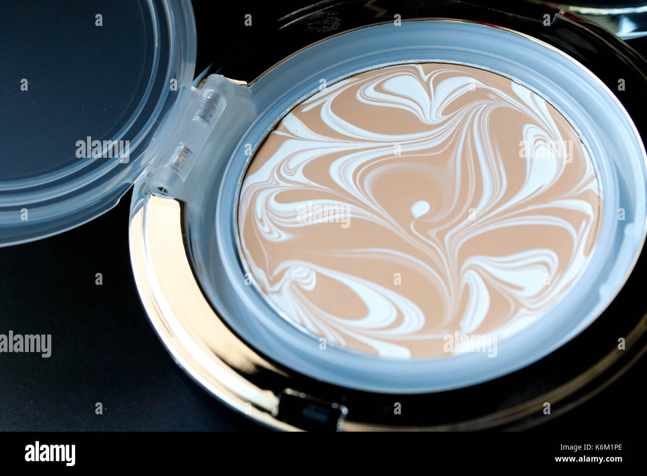 Compact foundation with swirls which contains moisturizer Stock Photo ...