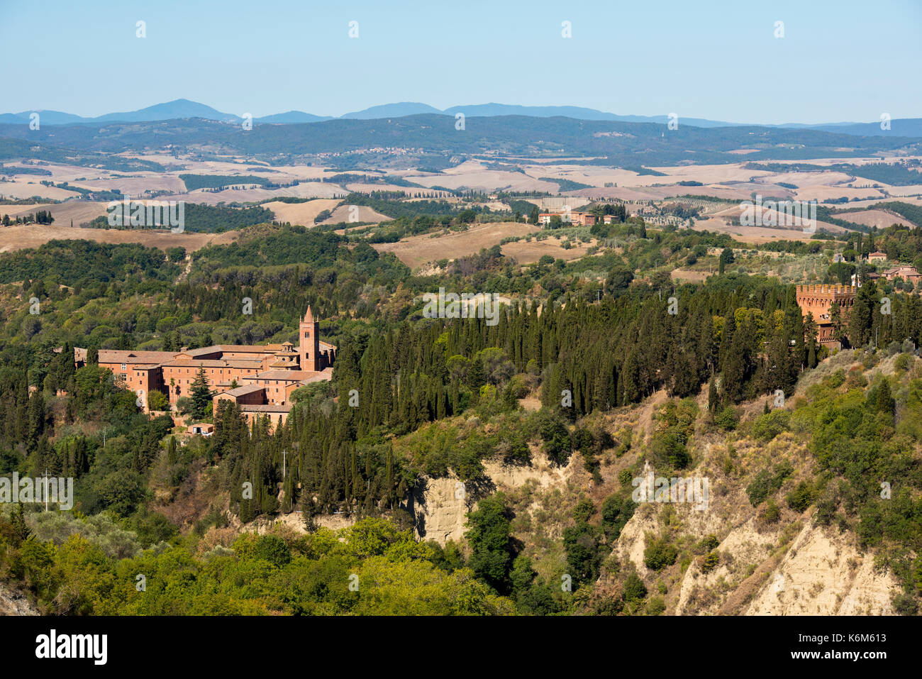 View of the Abbazia di Monte Oliveto Maggiore from Chiusure, Tuscany ...