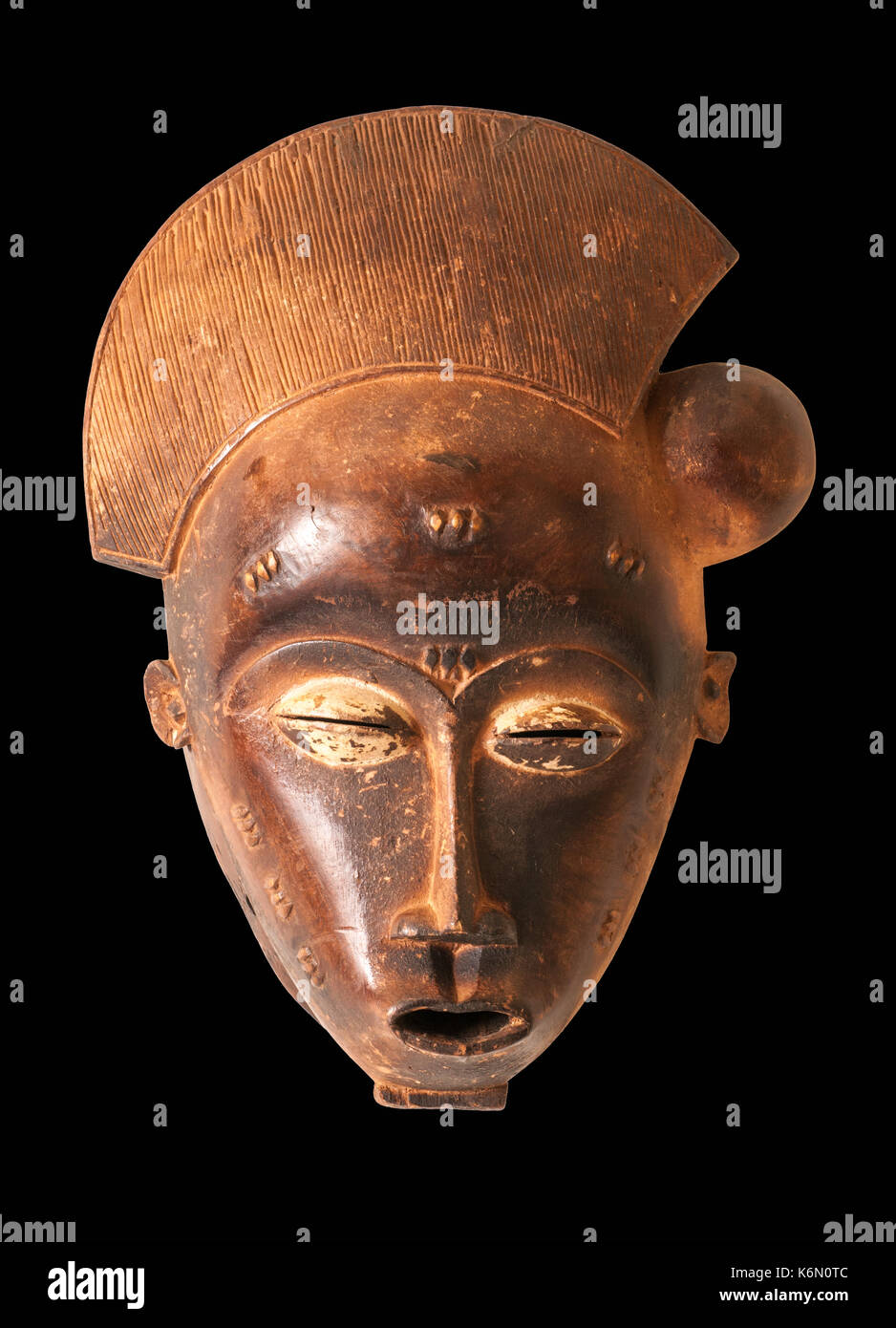 An African ceremonial mask in the form of a female figure carved in ...