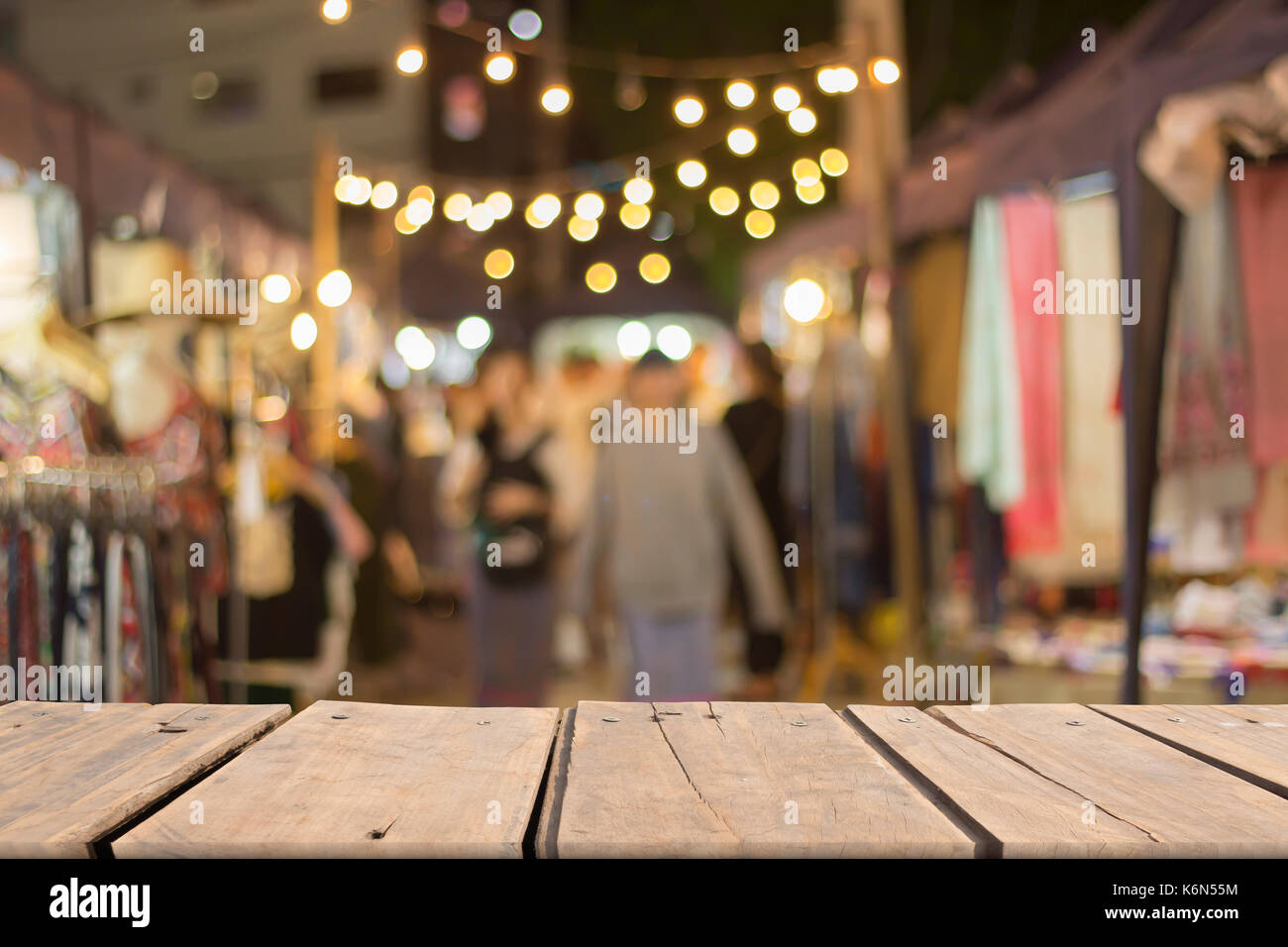 wooden table on front with blurred walking street night market ...