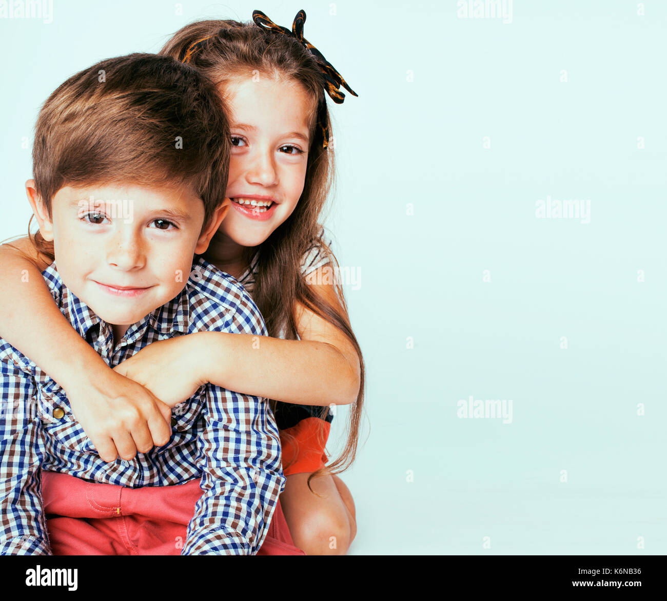 little cute boy and girl hugging playing on white background, ha Stock Photo - Alamy