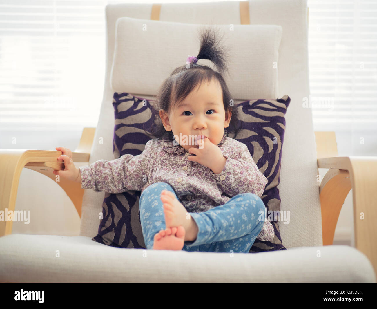 cute baby girl sitting on rocking chair Stock Photo - Alamy