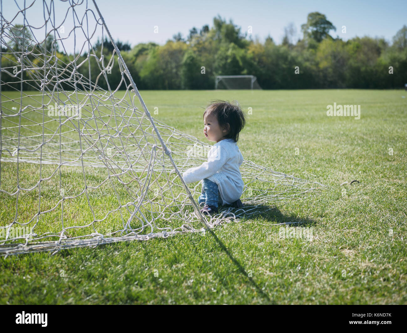 baby girl playing on football playground Stock Photo - Alamy