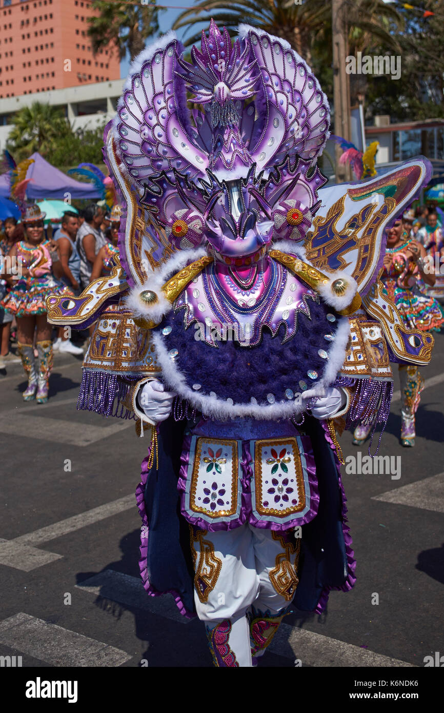 Masked Morenada dancer performing during a street parade at the annual ...