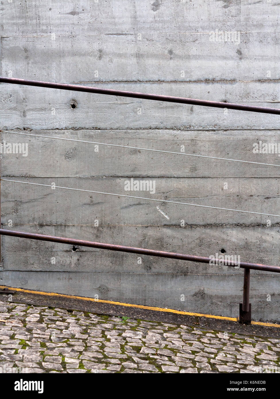 ramp with iron railing and background concrete wall Stock Photo - Alamy