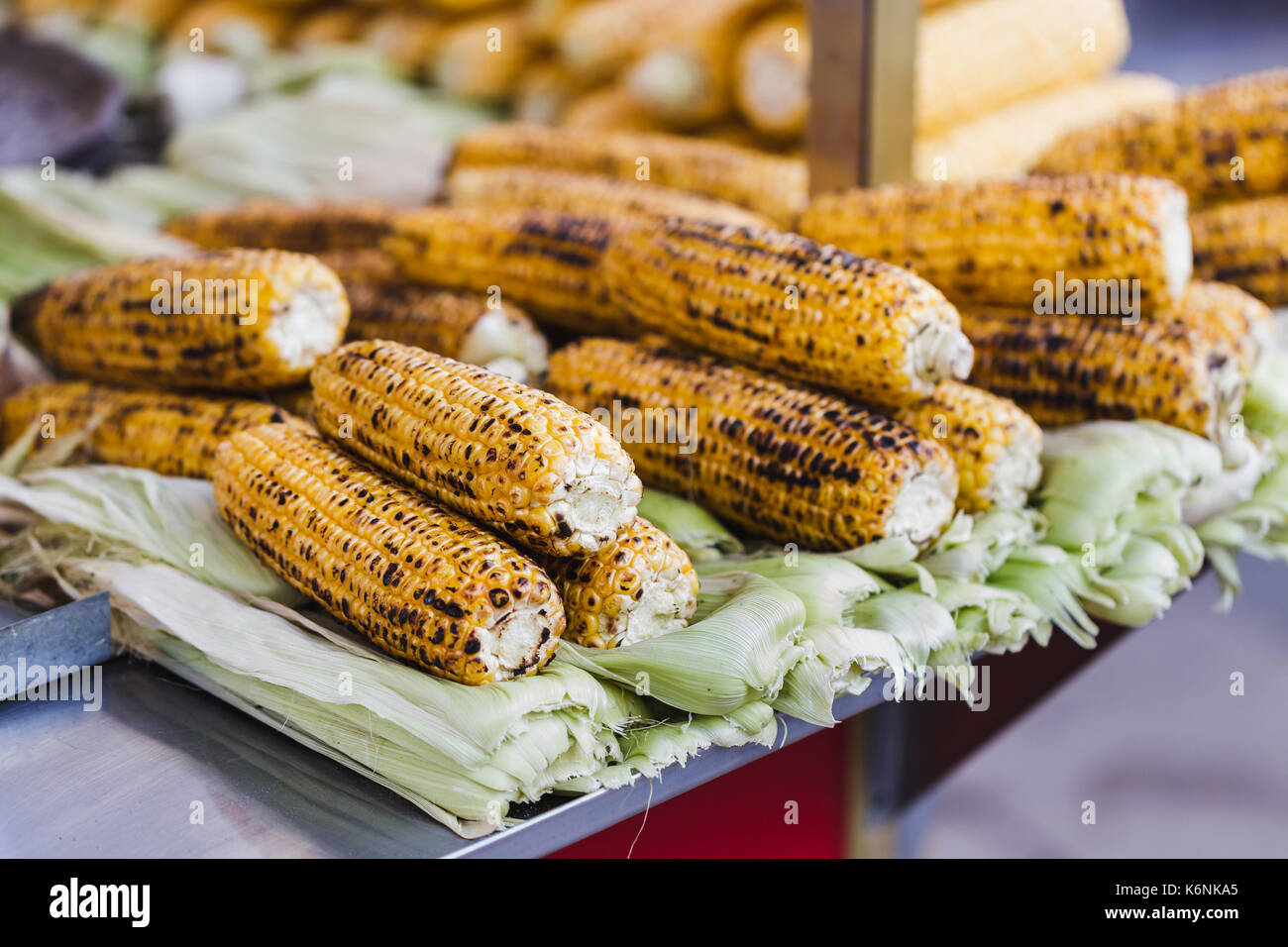 Hot and flavorful grilled corn close up. Asian street food Stock Photo ...