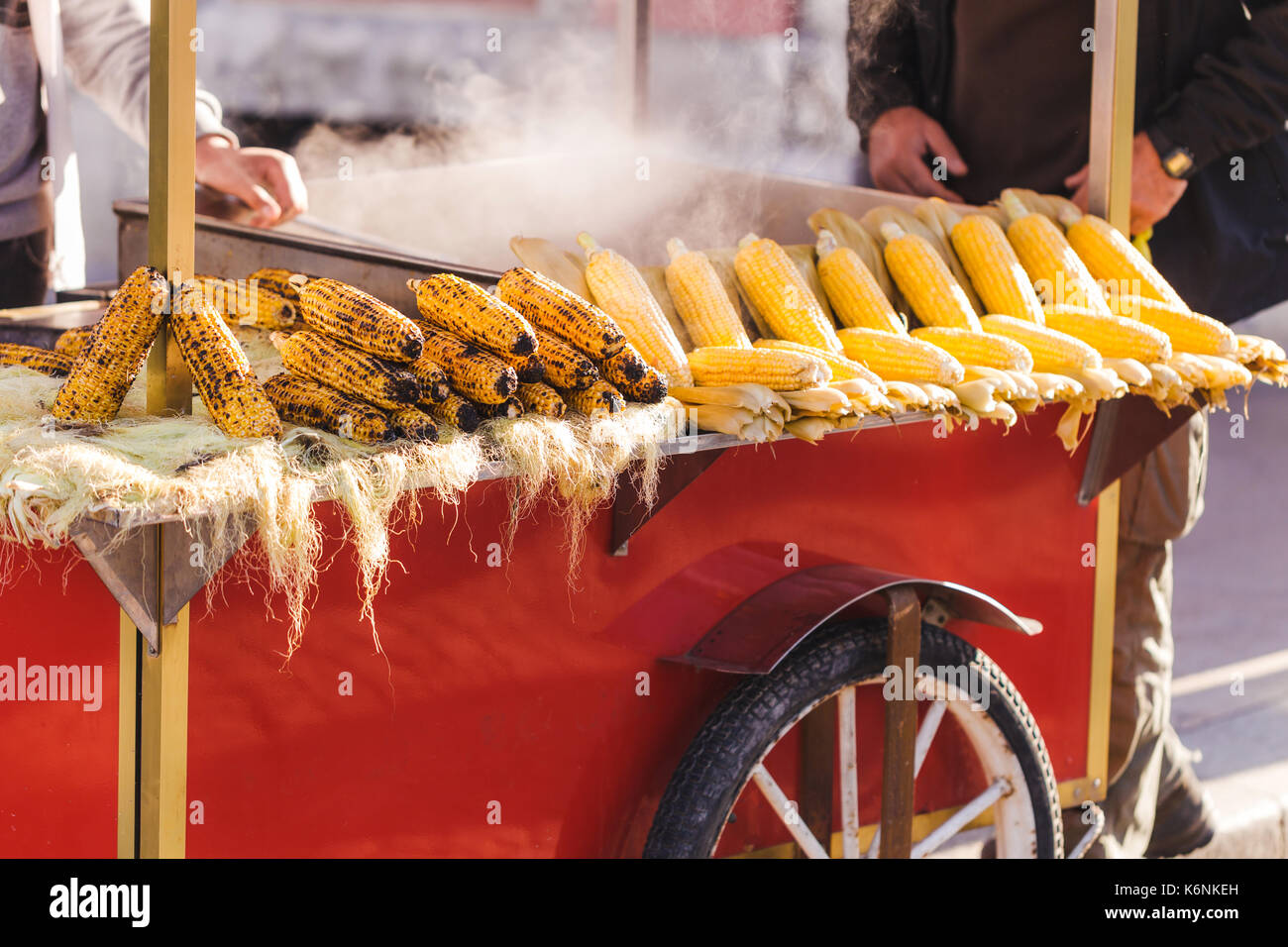 Preparing hot grilled corn outdoors at summer. Asian street food Stock ...