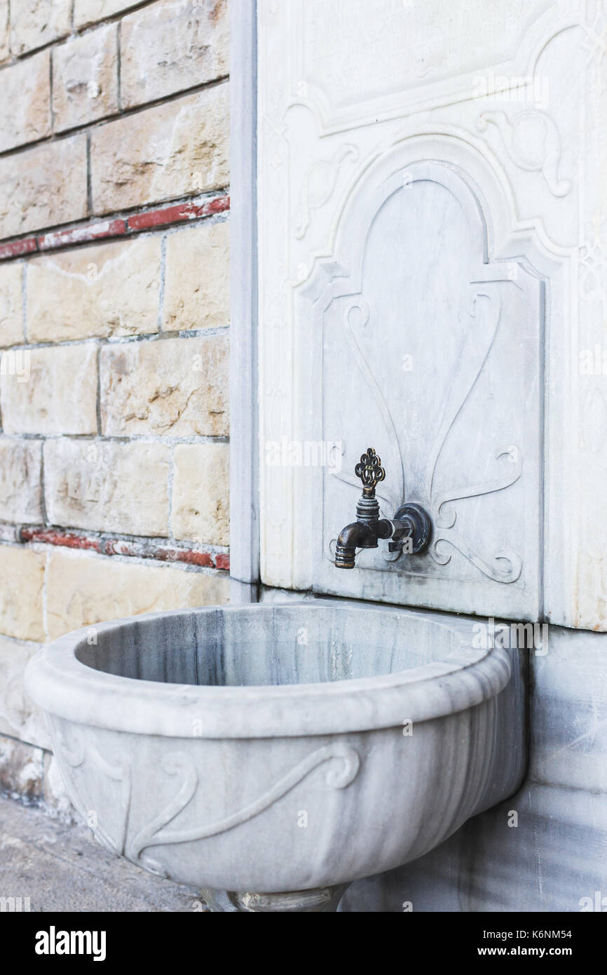 Old street washbasin with a few taps. With beautiful marble texture ...