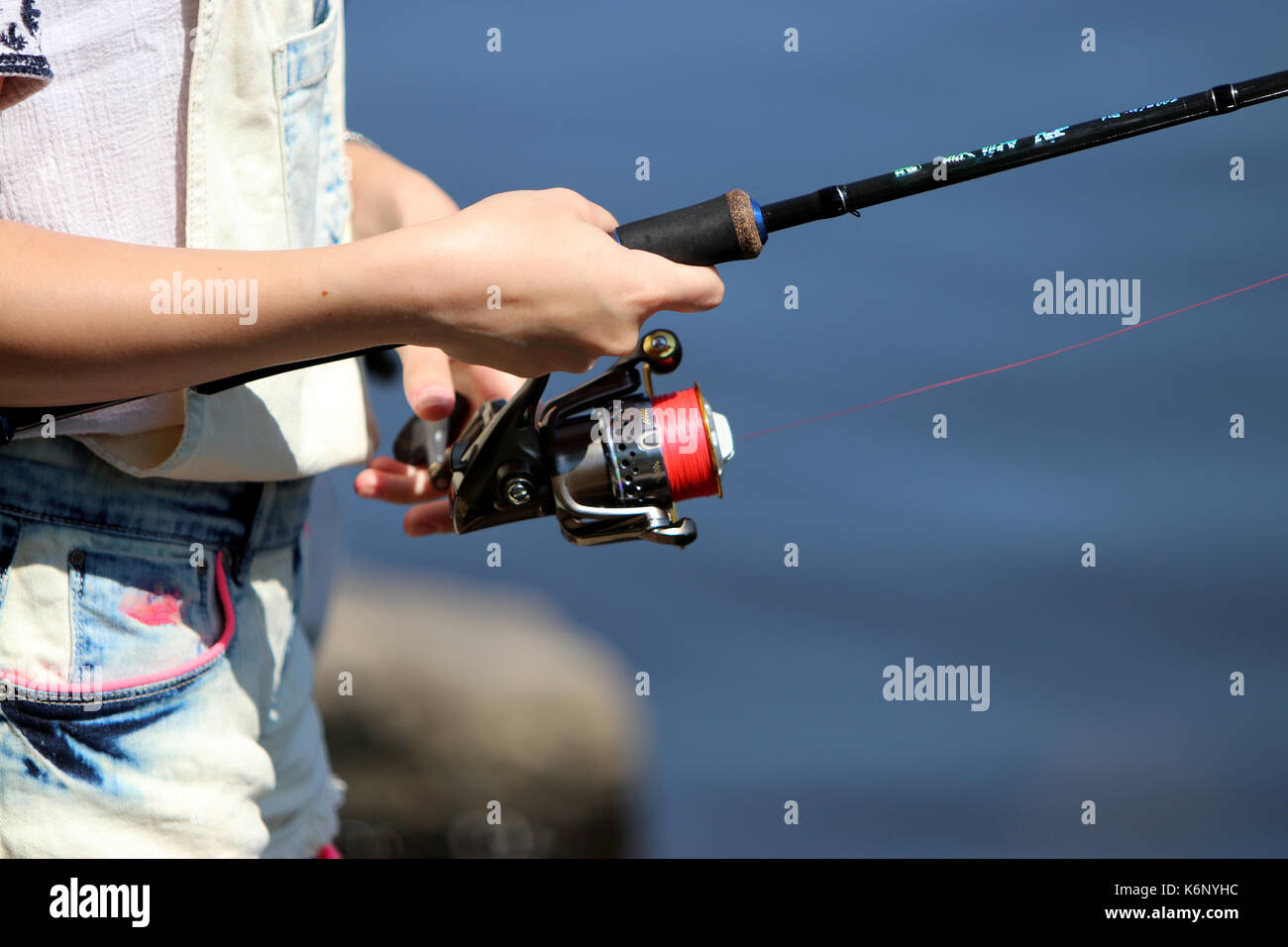 Woman with freckles and hot pants while fishing Stock Photo - Alamy