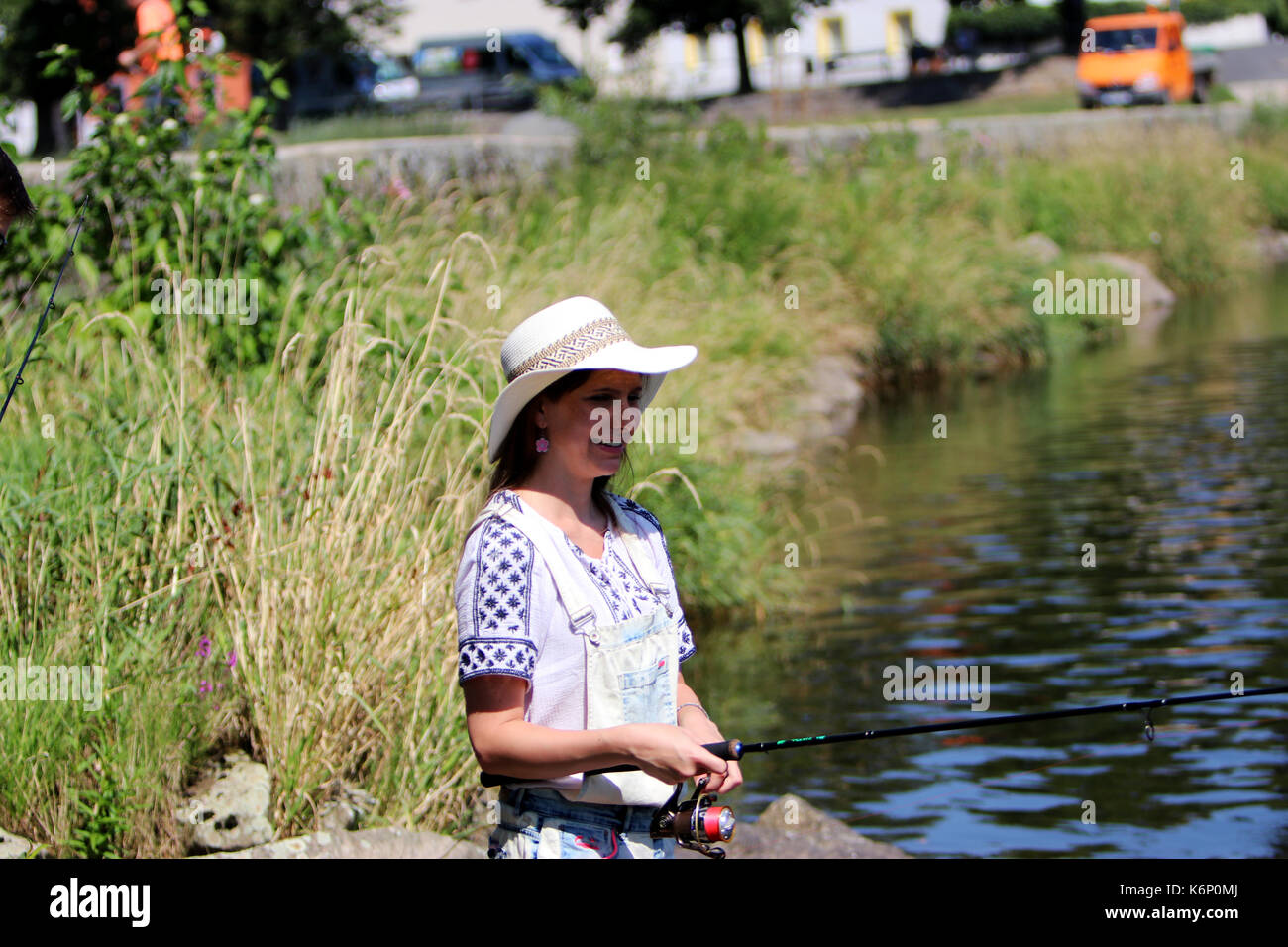 Woman with freckles and hot pants while fishing Stock Photo - Alamy
