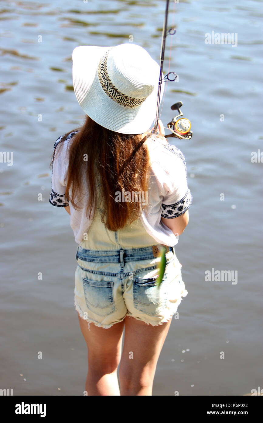 Woman with freckles and hot pants while fishing Stock Photo - Alamy