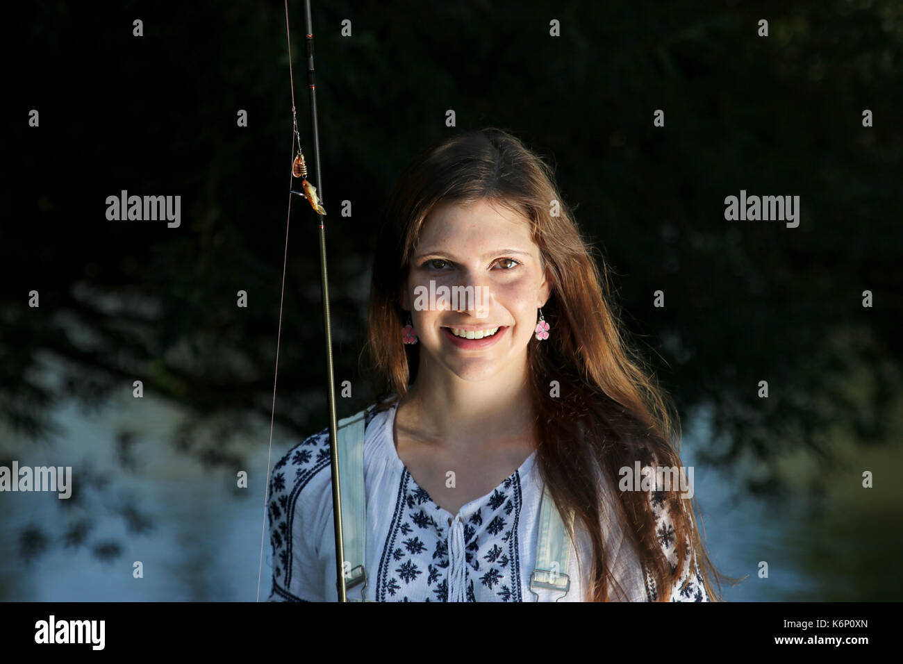 Woman with freckles and hot pants while fishing Stock Photo - Alamy