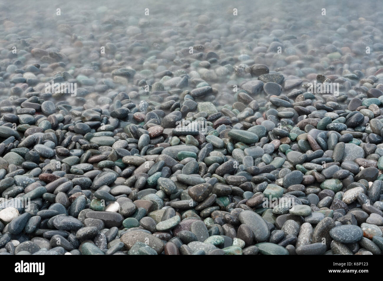 Pebbles washed by waves on a shingle beach, rocky seaside area ...